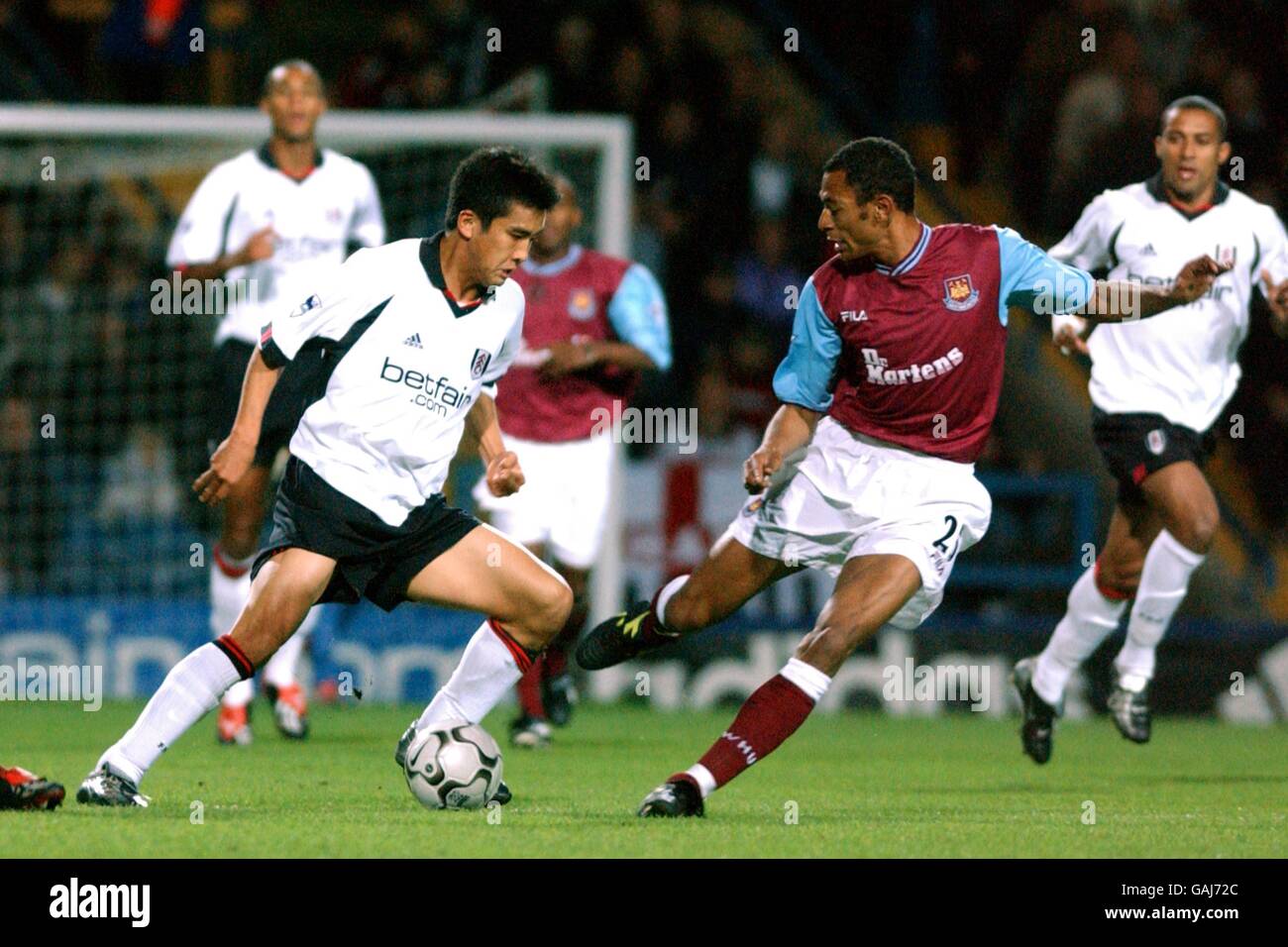 Fulham's Junichi Inamoto keeps the ball from West Ham United's Edouard ...