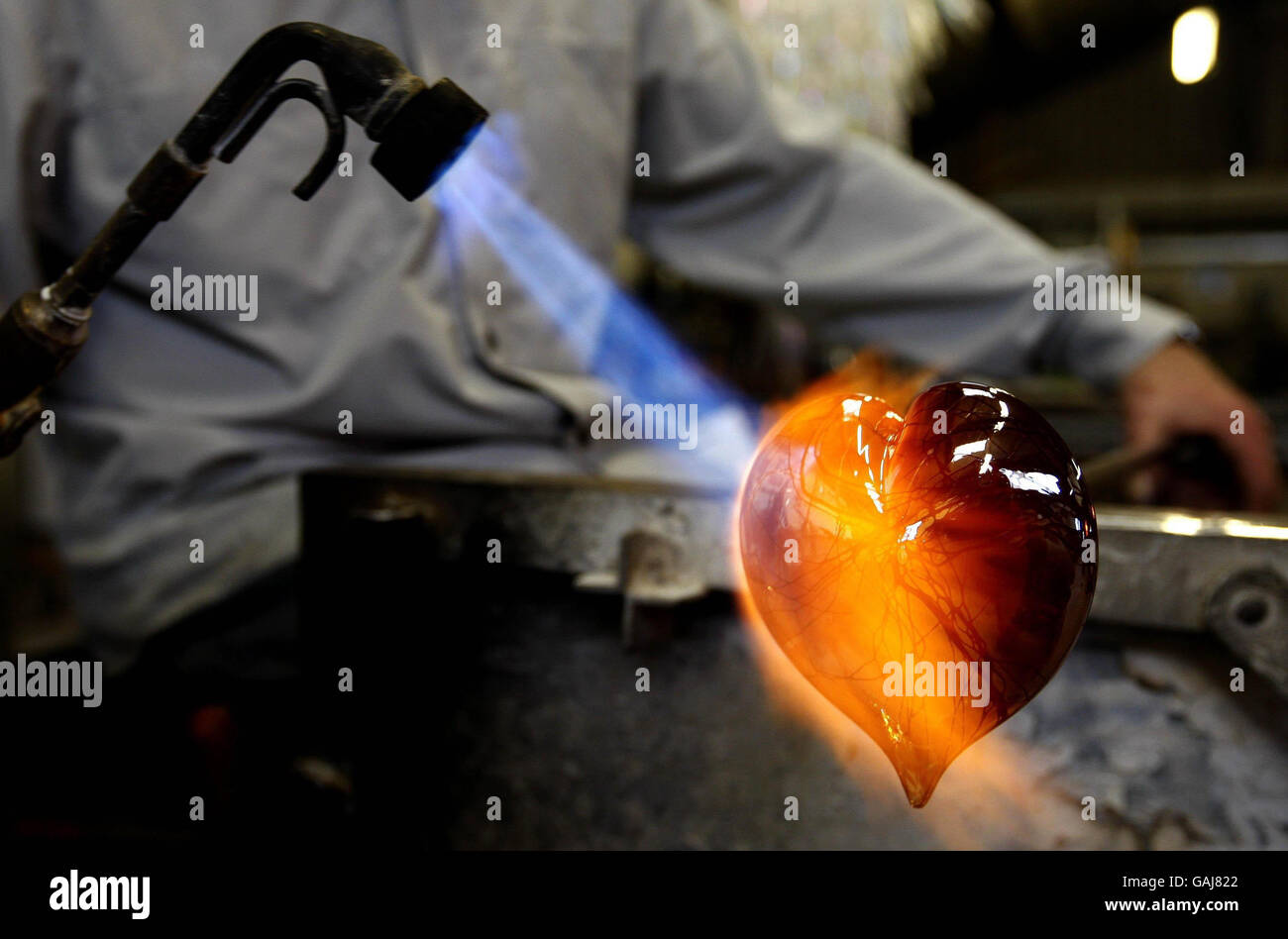 Glassblower John Ditchfield creates a heart shaped glass paperweight at ...