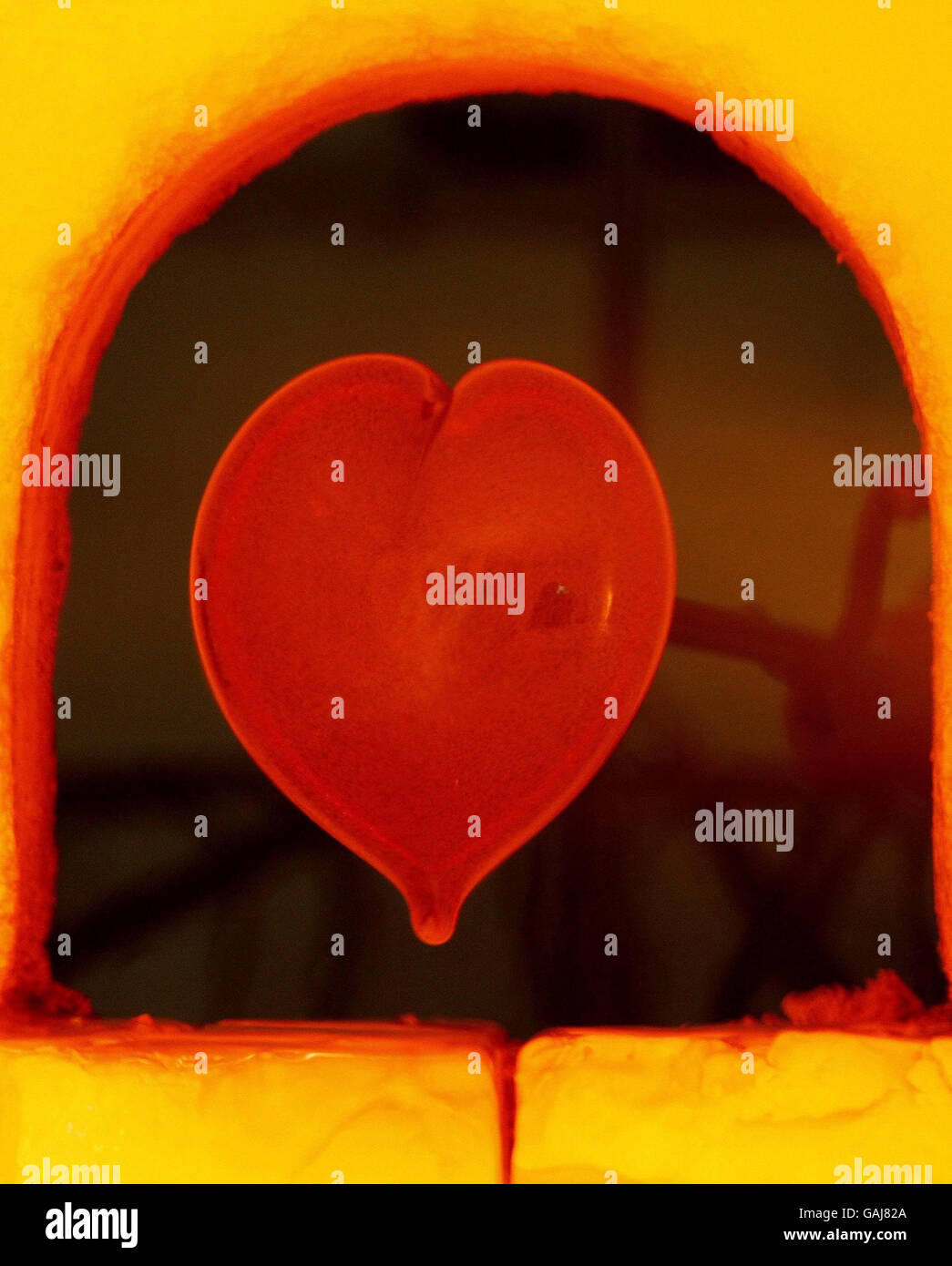Glassblower John Ditchfield creates a heart shaped glass paperweight at ...