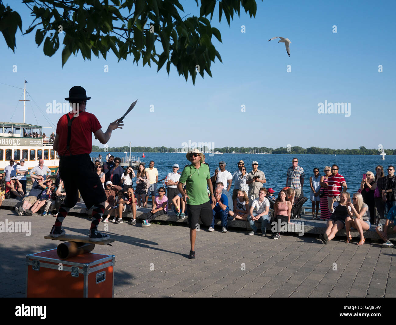 Juggler performing in front of an audience in Lake Ontario ...