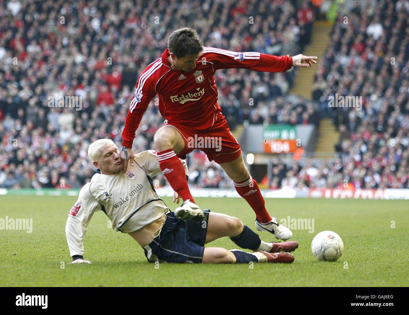 Liverpool's Harry Kewell and Barnsley's Bobby Hassell battle for the ...
