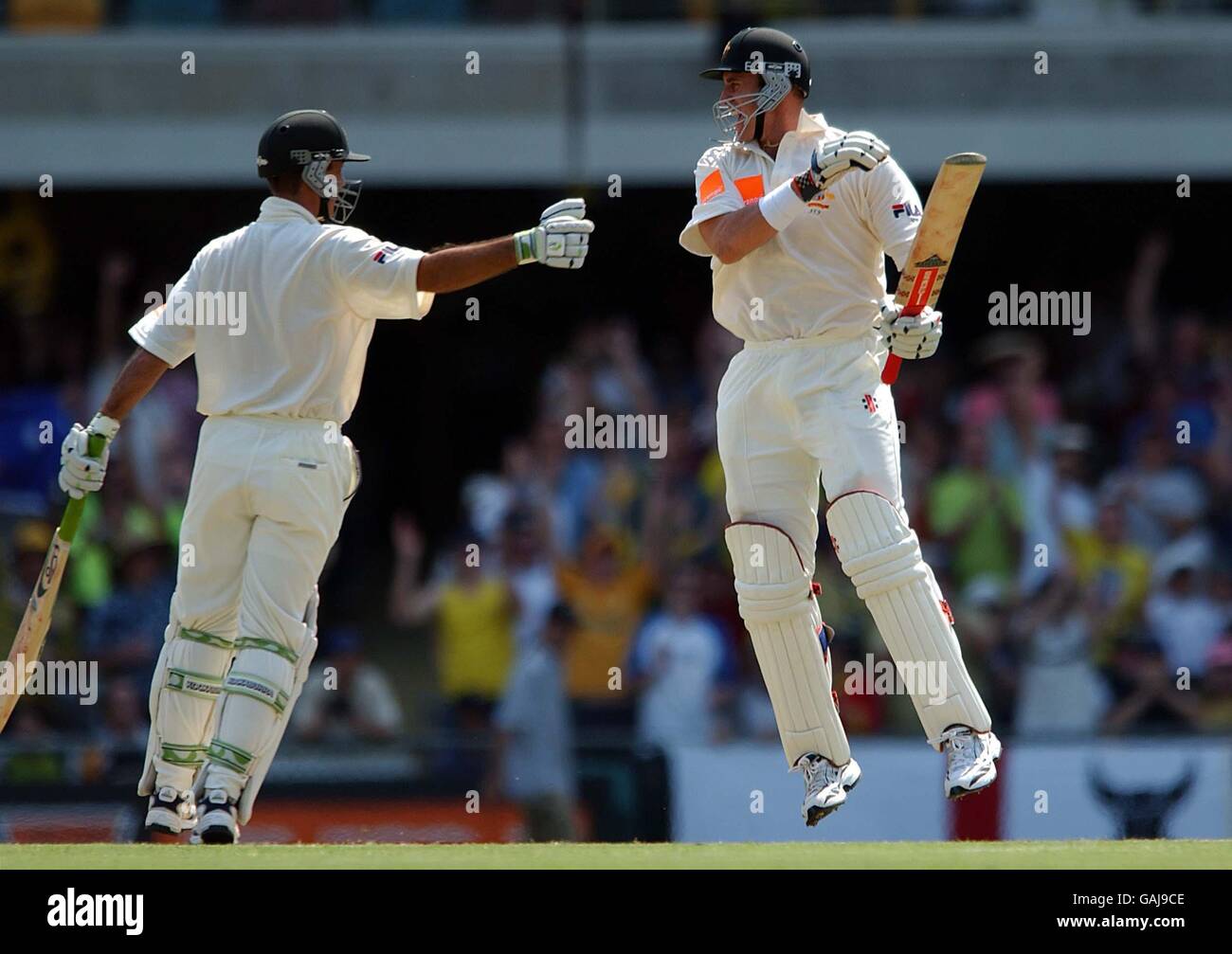 Australia's Matthew Hayden (R) jumps up as he celebrates his century ...