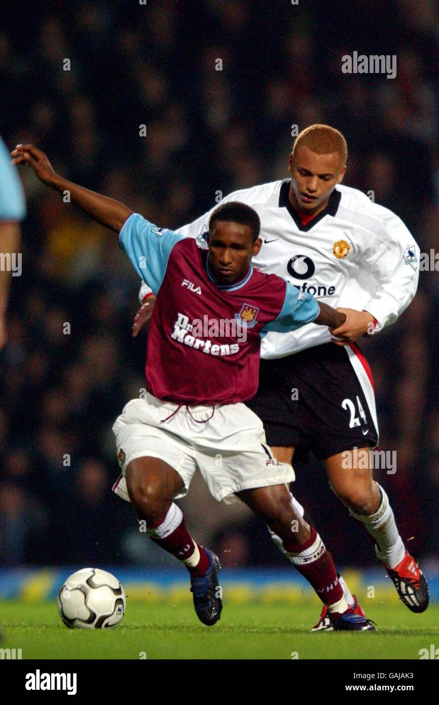 West Ham United's Jermain Defoe (l) is marked closely by Manchester ...