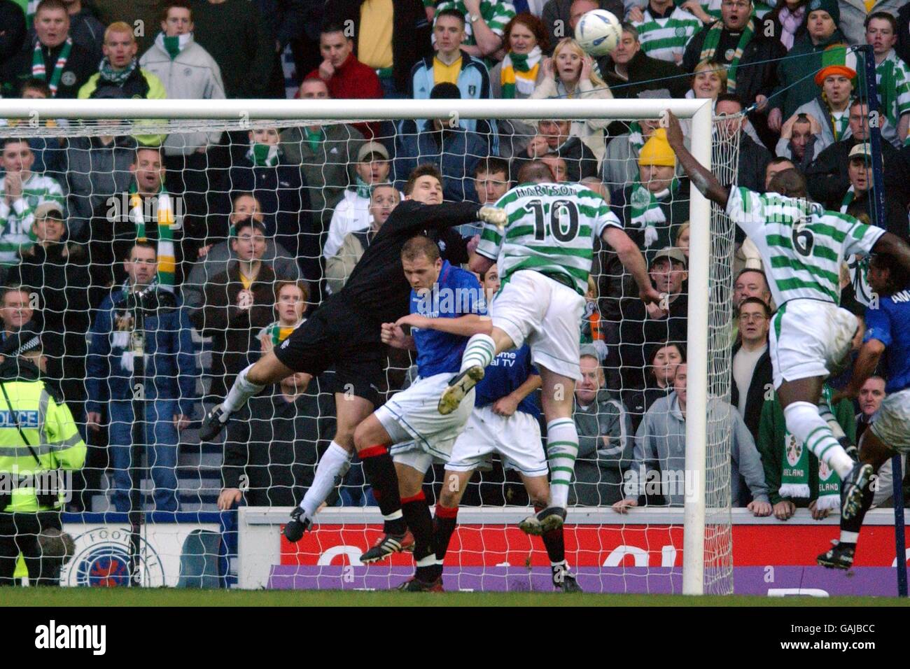 Rangers' goalkeeper Stefan Klos punches the ball clear under pressure ...