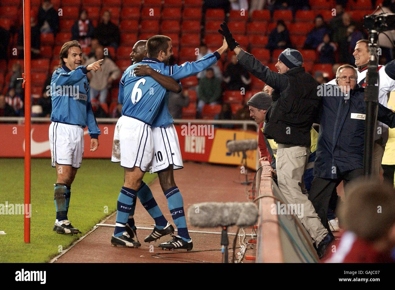 Manchester City's Kevin Horlock gives a travelling fan a high five as ...