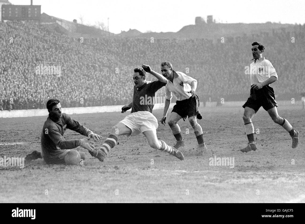Blackpool goalkeeper George Farm (l) saves at the feet of Charlton ...