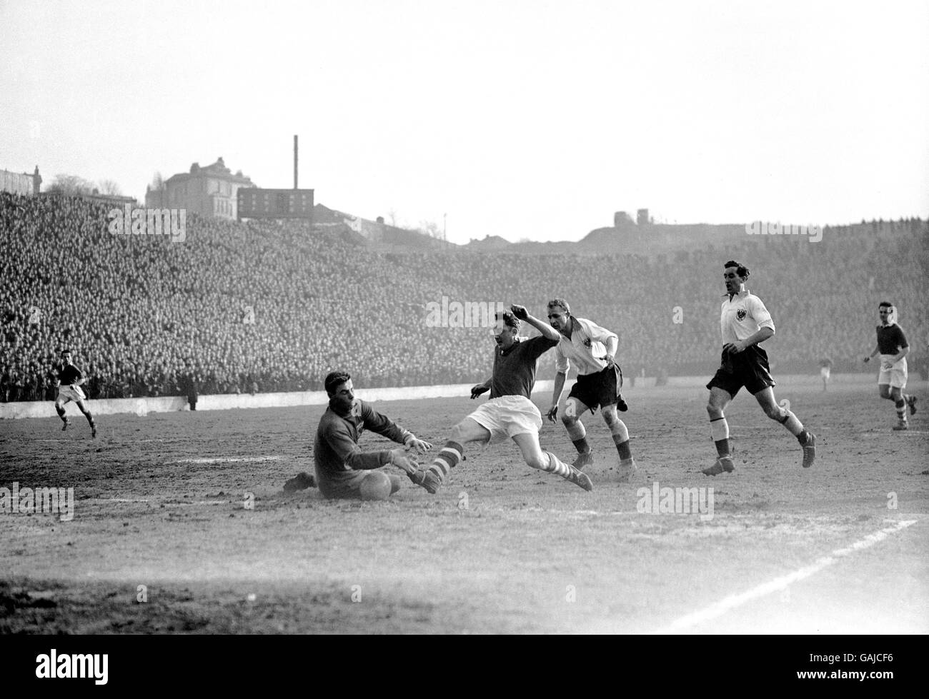 Blackpool goalkeeper George Farm (l) saves at the feet of Charlton ...