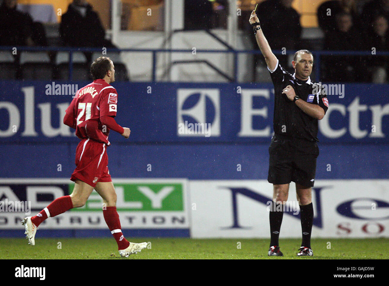 Match referee Carl Boyeson shows Swindon Town's Blair Sturrock (l) a ...