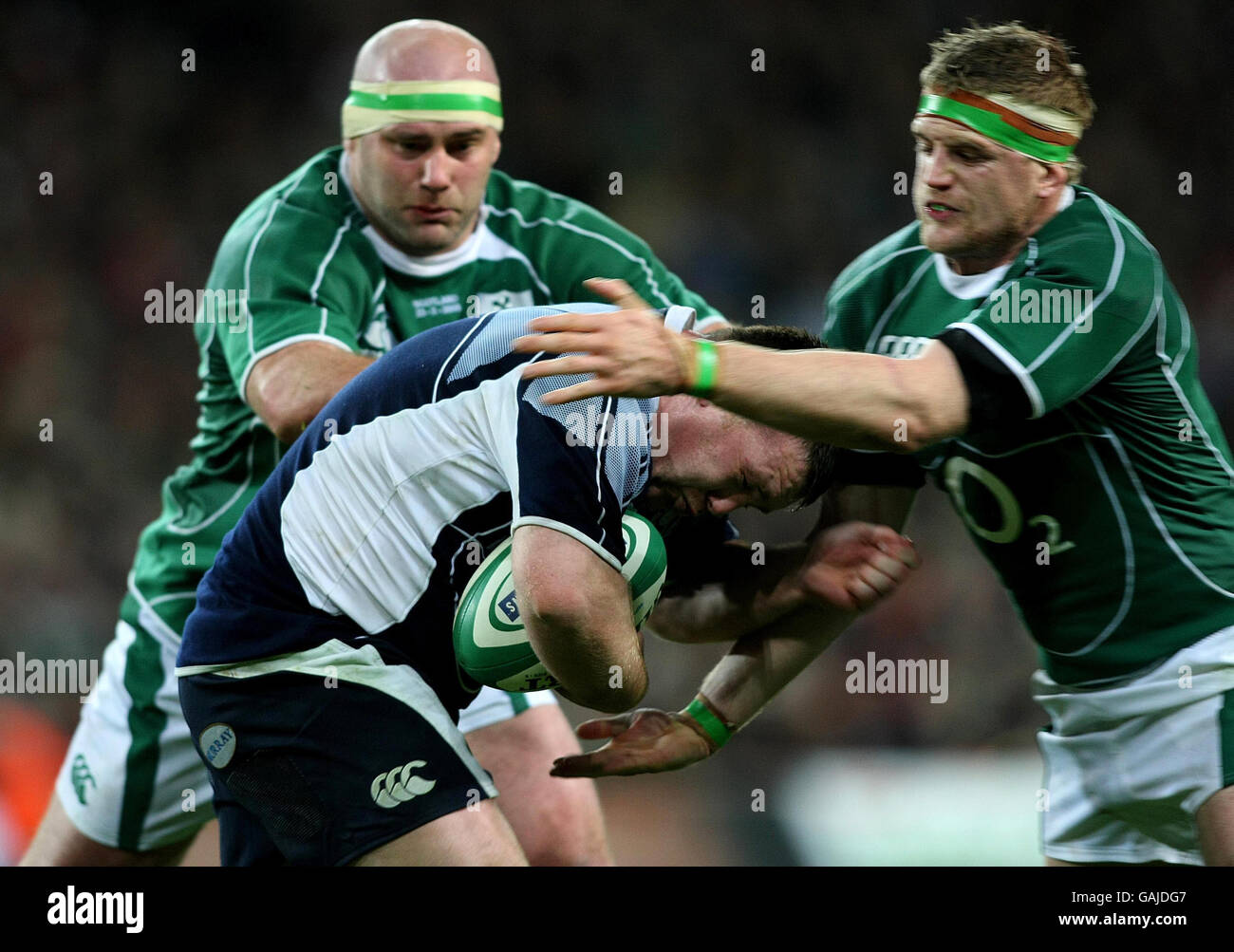 Ireland's John Hayes and Jamie Heaslip tackling with Scotland's Alan ...