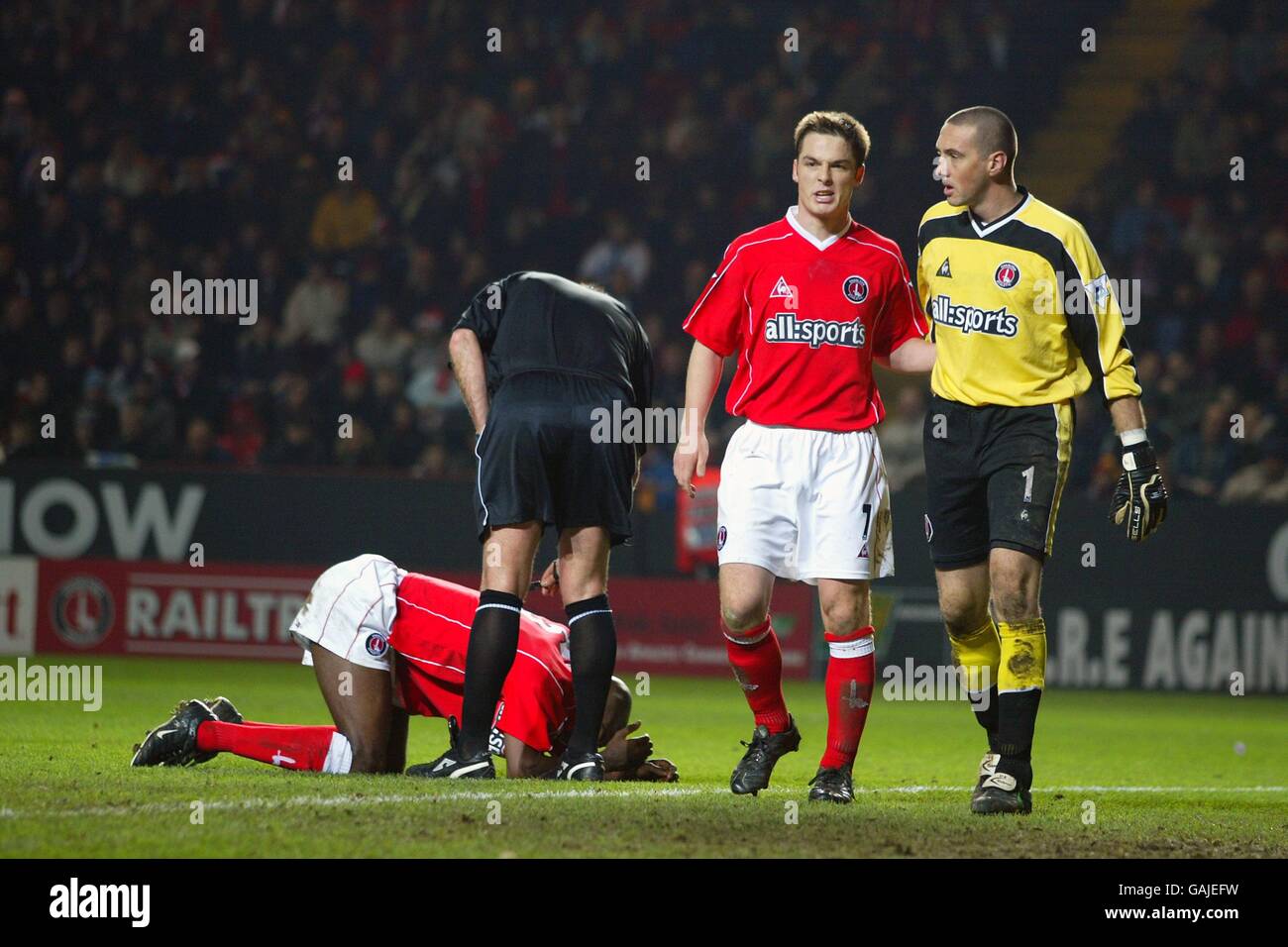 (L-R) Charlton Athletic's Richard Rufus is helped with his injuries by ...