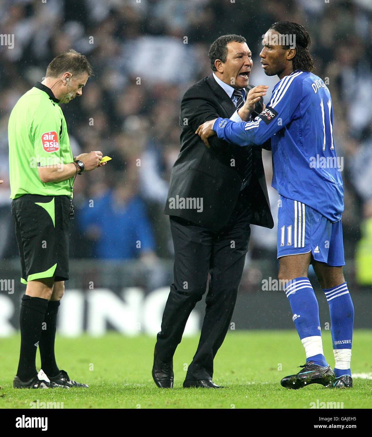 Chelsea coach Henk Ten Cate stops Didier Drogba from talking to referee ...