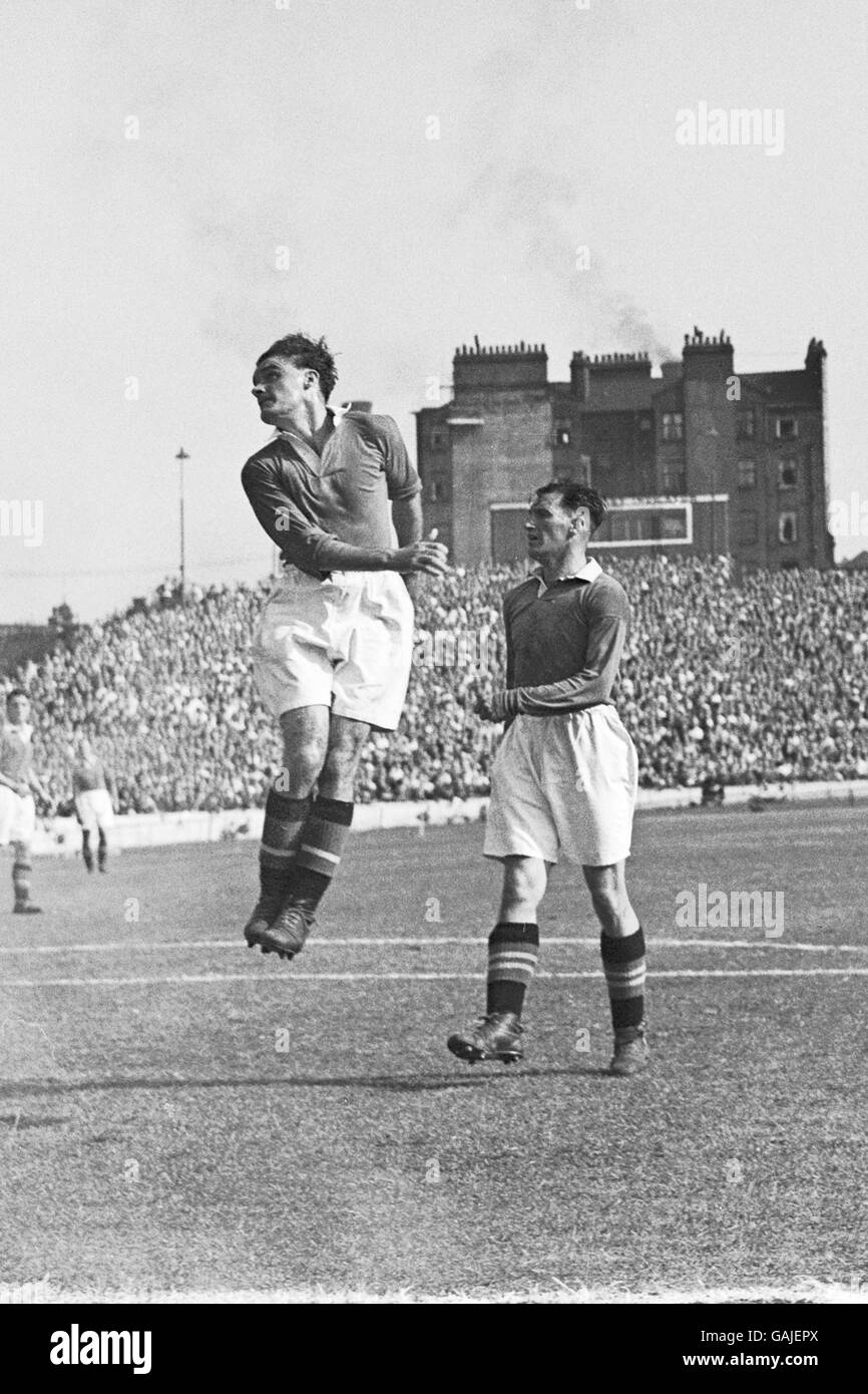 L r manchester uniteds stan pearson rises to head the ball hi-res stock ...