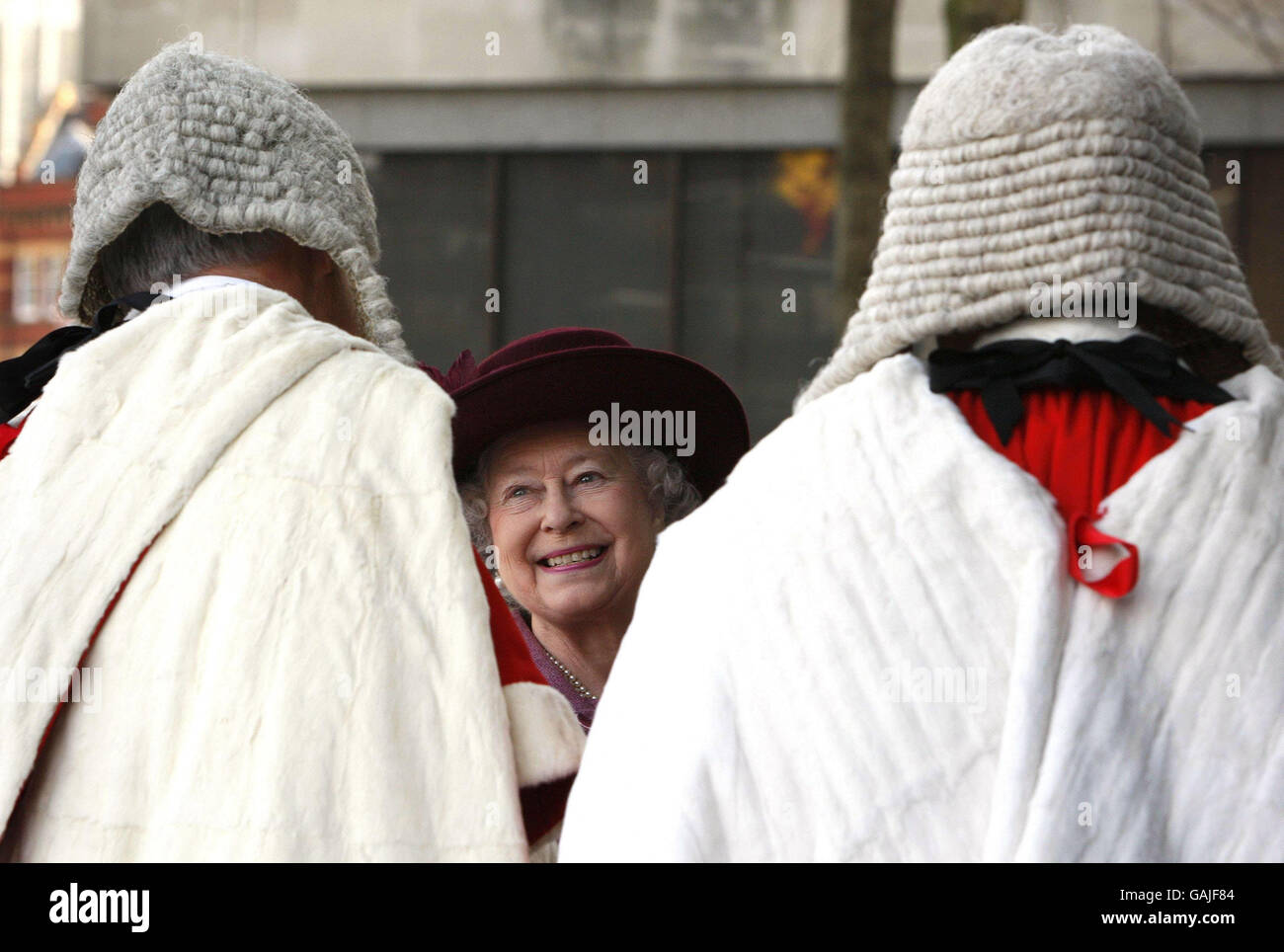 Britain's Queen Elizabeth II speaks with a judge after opening the new ...