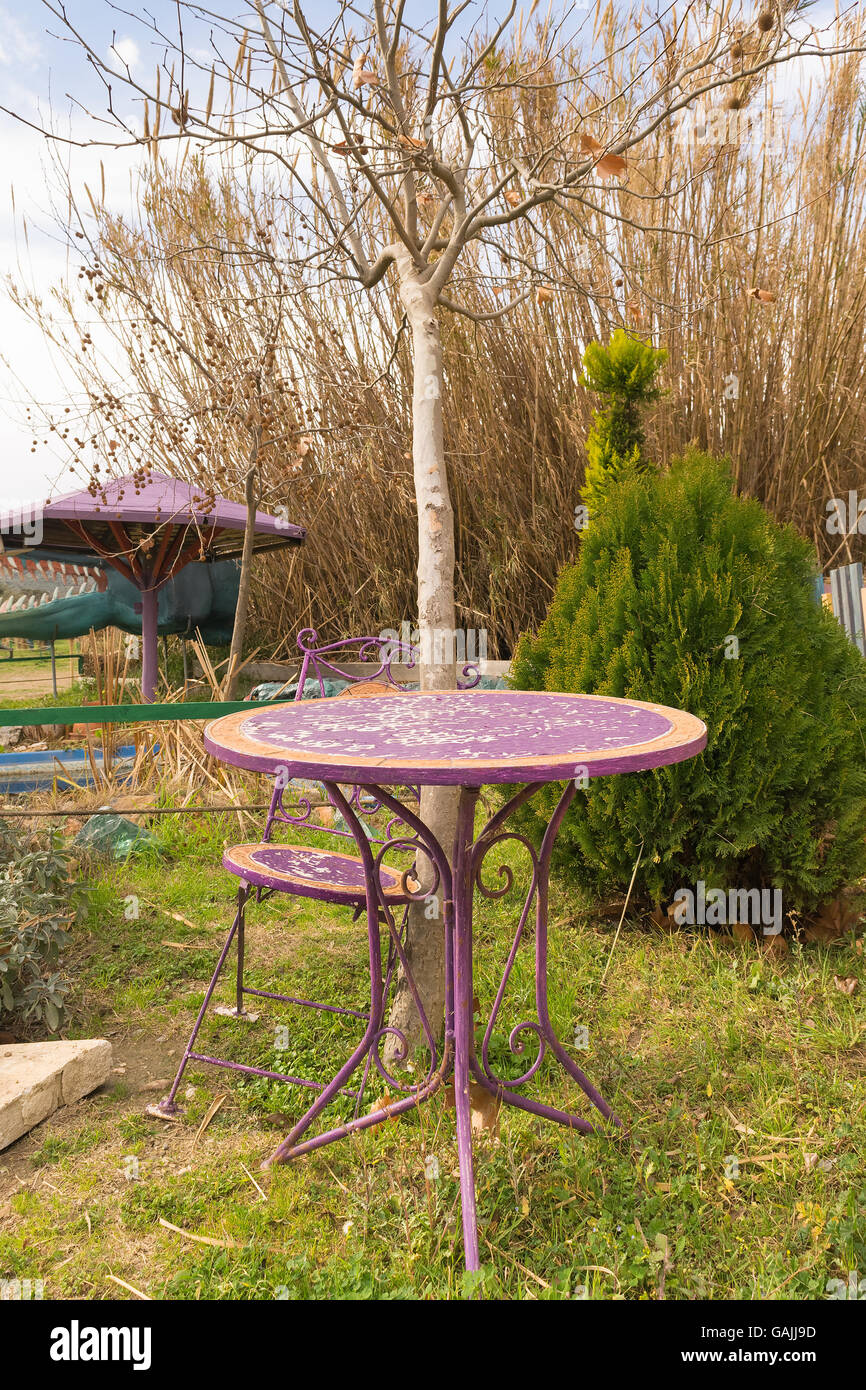 Beautiful pink table against a tree and the sky outside in the nature ...