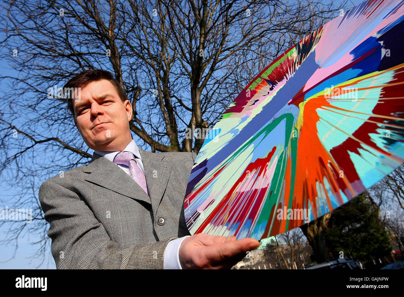 Auctioneer Garrett O'Connor in Dublin holding the prized Damien Hirst ...