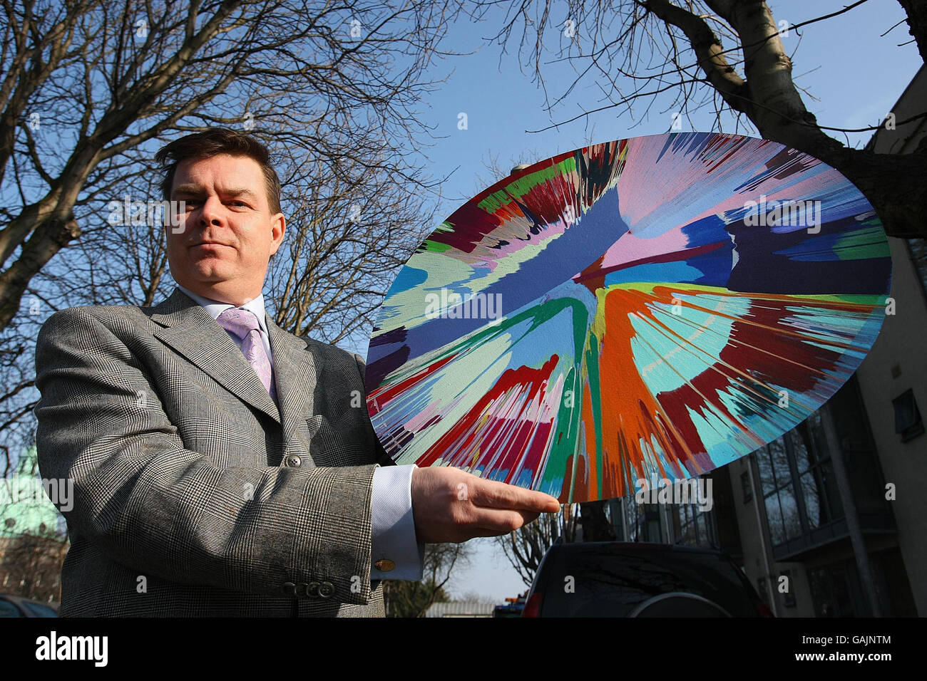 Auctioneer Garrett O'Connor in Dublin holding the prized Damien Hirst ...