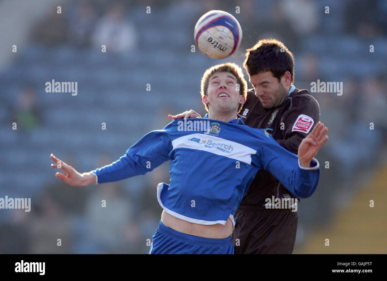 Stockport County's Dominic Blizzard (l) battles for the ball with Bury ...
