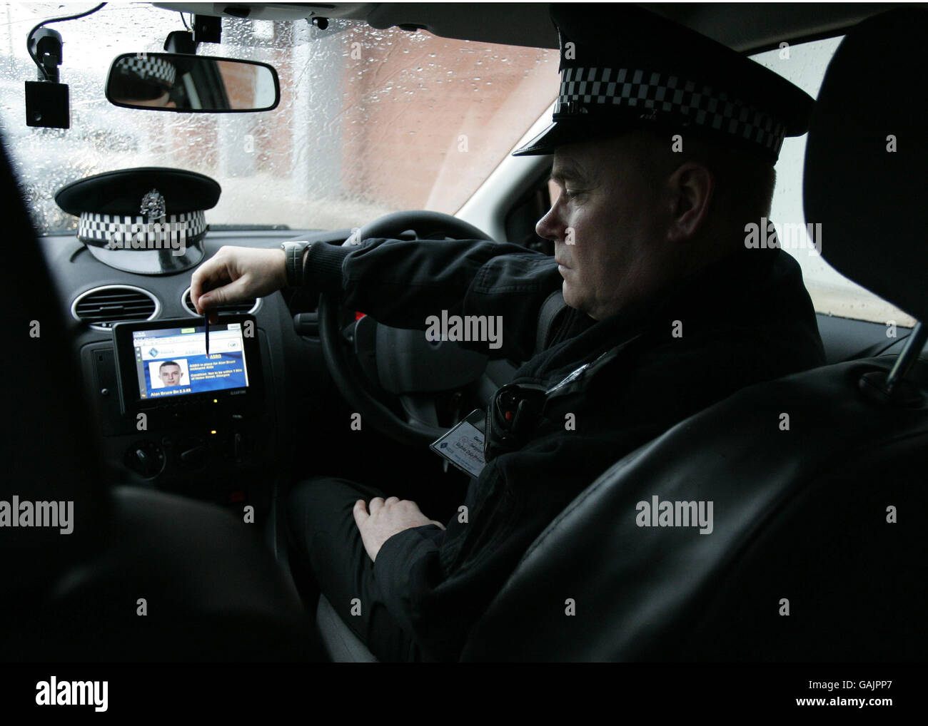 A Strathclyde Police officer using a new integrated computer system ...