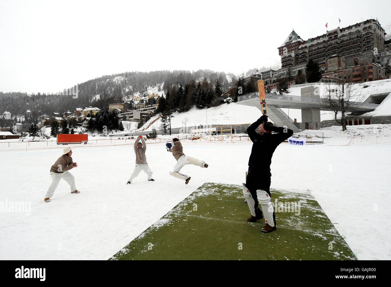 Cricketers play on ice during the round robin tournament which ...