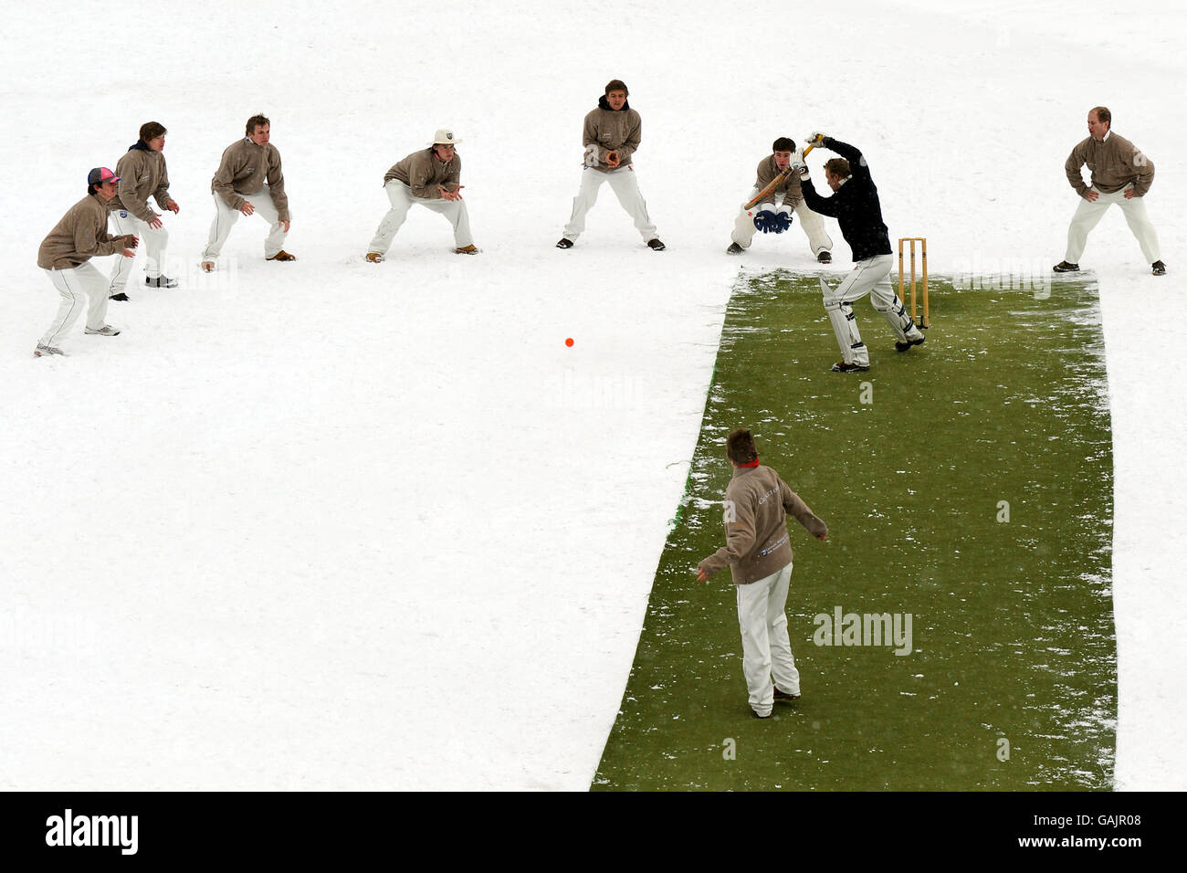 Cricketers play on ice during the round robin tournament which ...