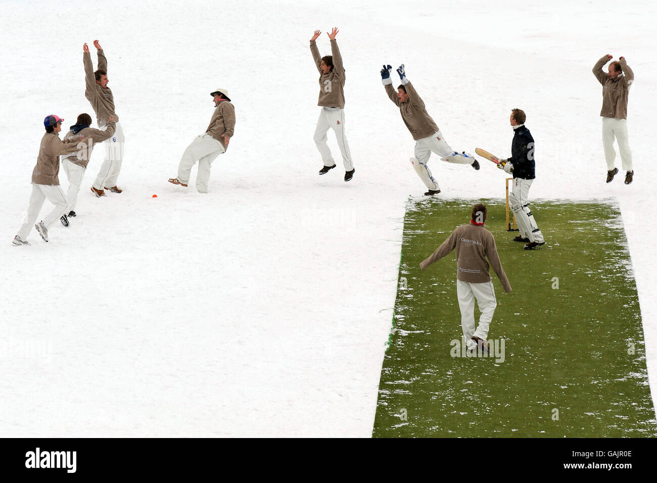 Cricketers play on ice during the round robin tournament which ...