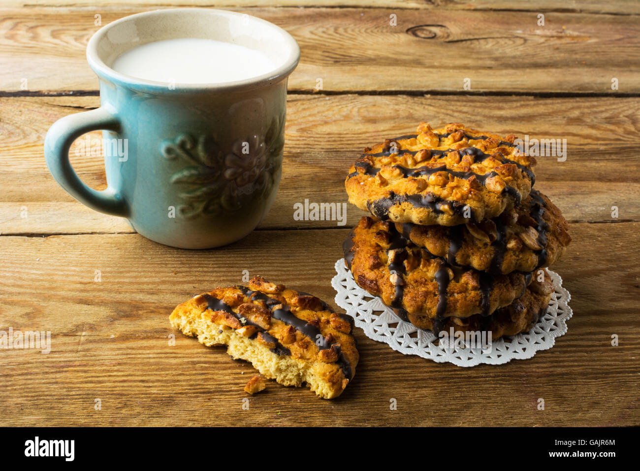 Cookies coating chocolate and milk on a rustic wooden table Stock Photo ...