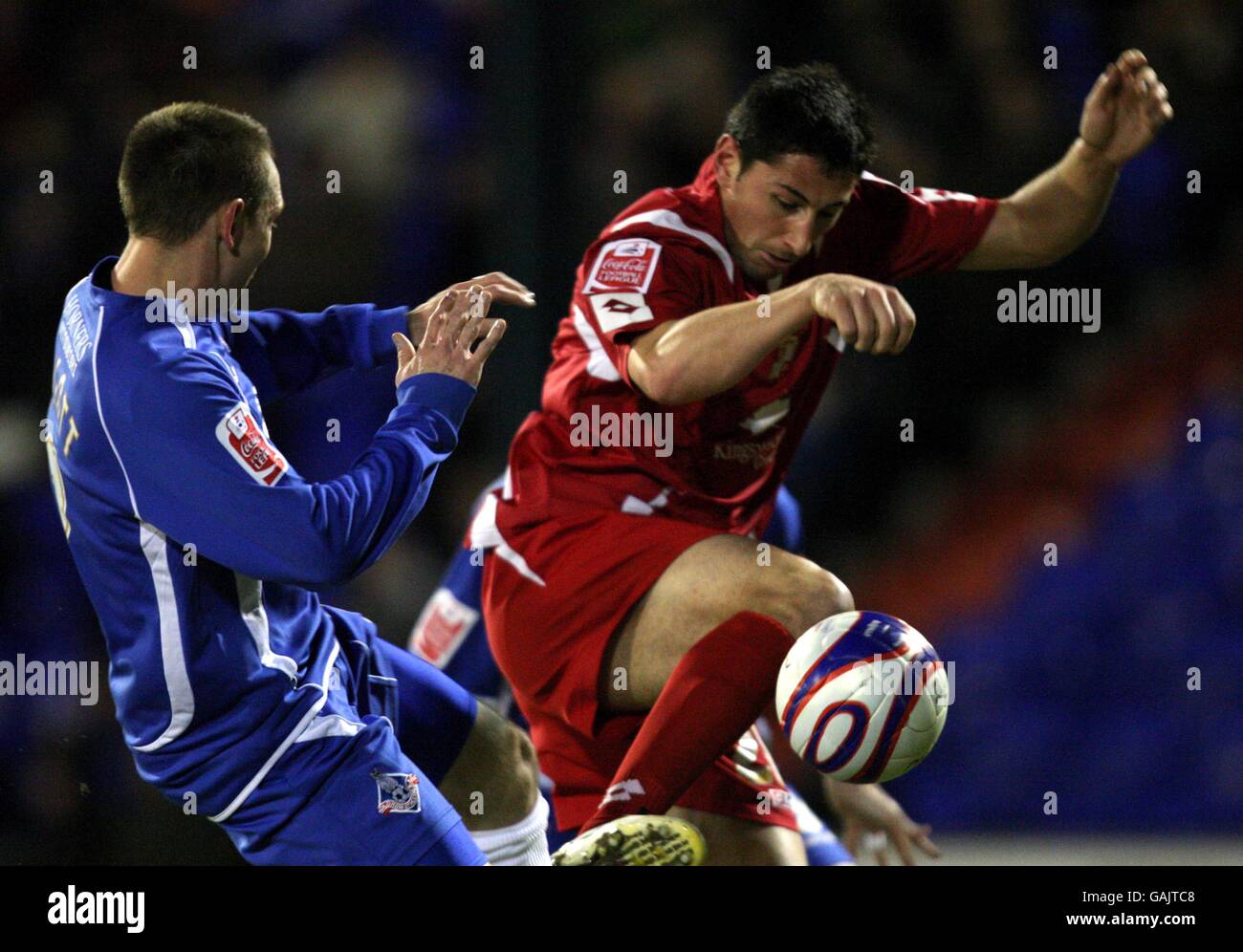 Oldham's Mark Allott and Swindon Town's Billy Paynter compete for the ...