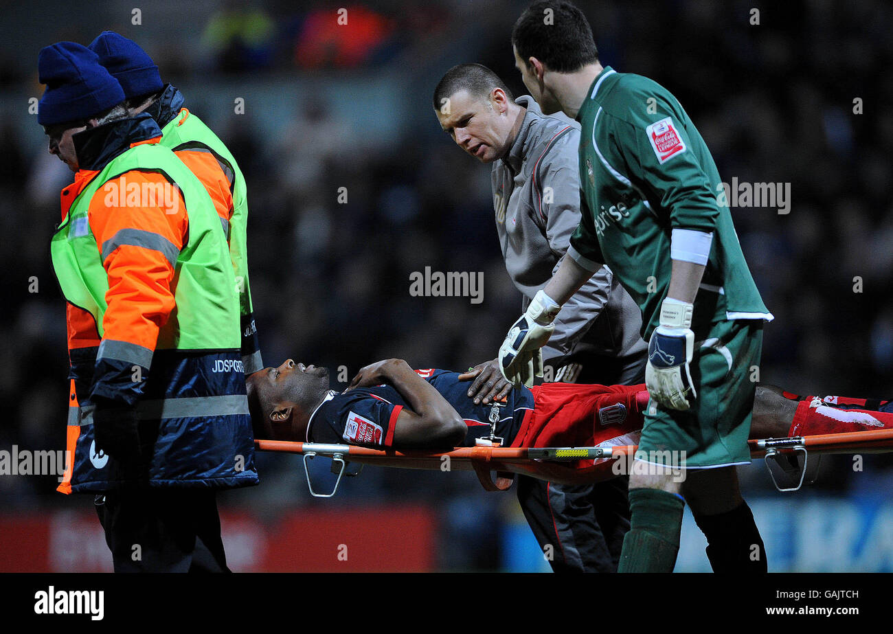 Stoke City's Leon Cort is consoled by Preston's Andy Lonergan as he is ...