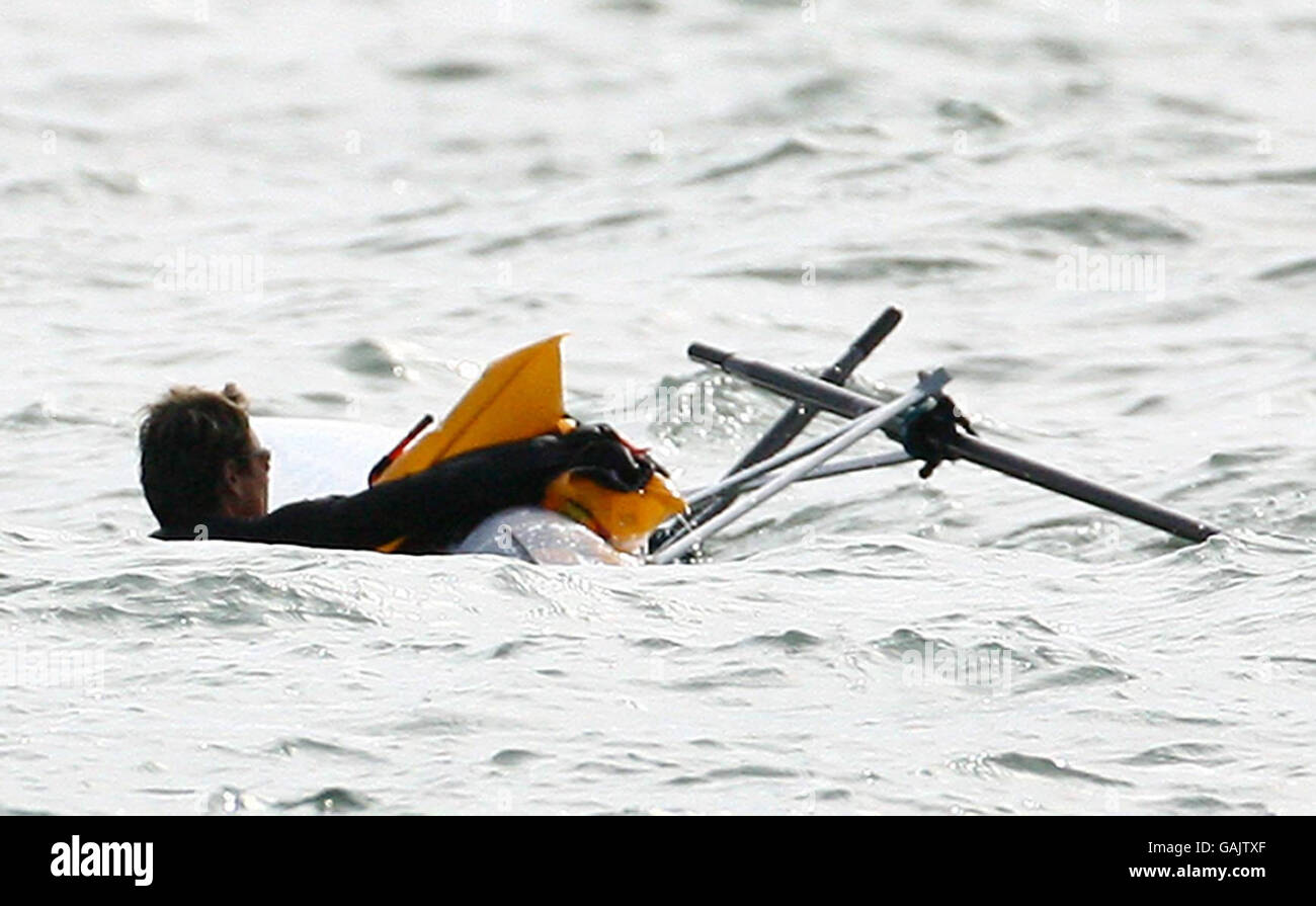 Olympic rower James Cracknell holds onto his boat after capsizing in ...