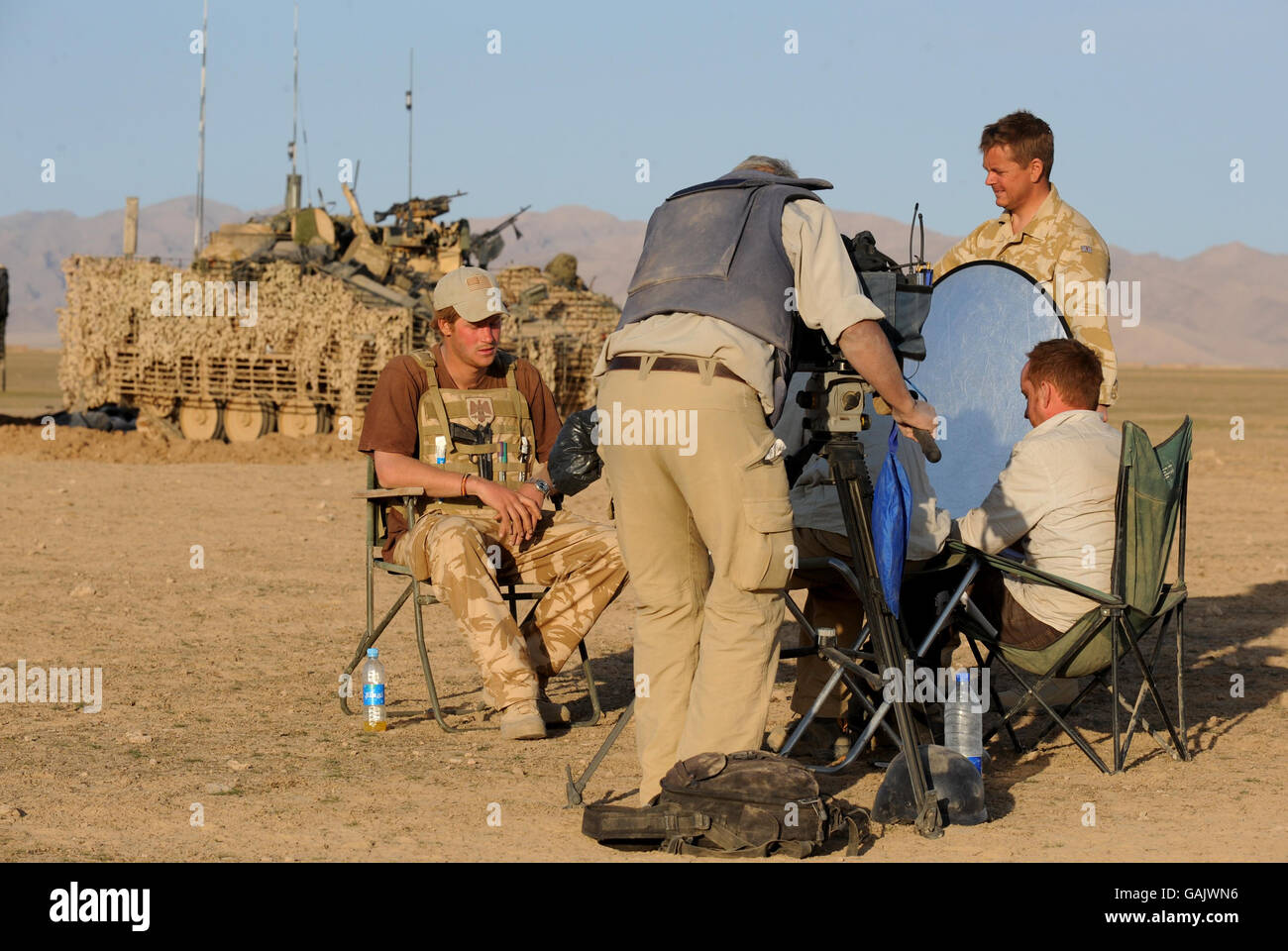 A TV news team interview Prince Harry in the desert in the Helmand ...