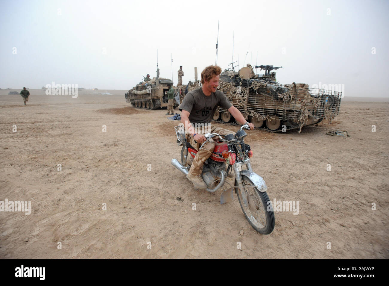 Prince Harry tries to start an abandoned motorcycle in the desert in ...
