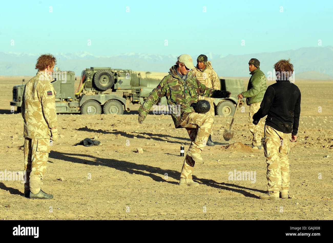 Prince Harry enjoys an early morning kick-about at dawn in the desert ...
