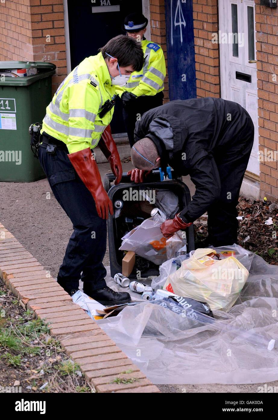 Police officers search through residents' bins in the Dewsbury Moor ...