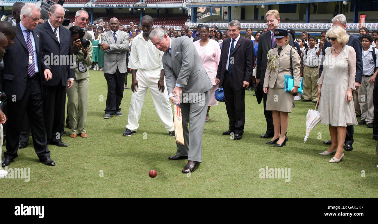 The Prince of Wales (centre) tries his hand with a cricket bat on a ...