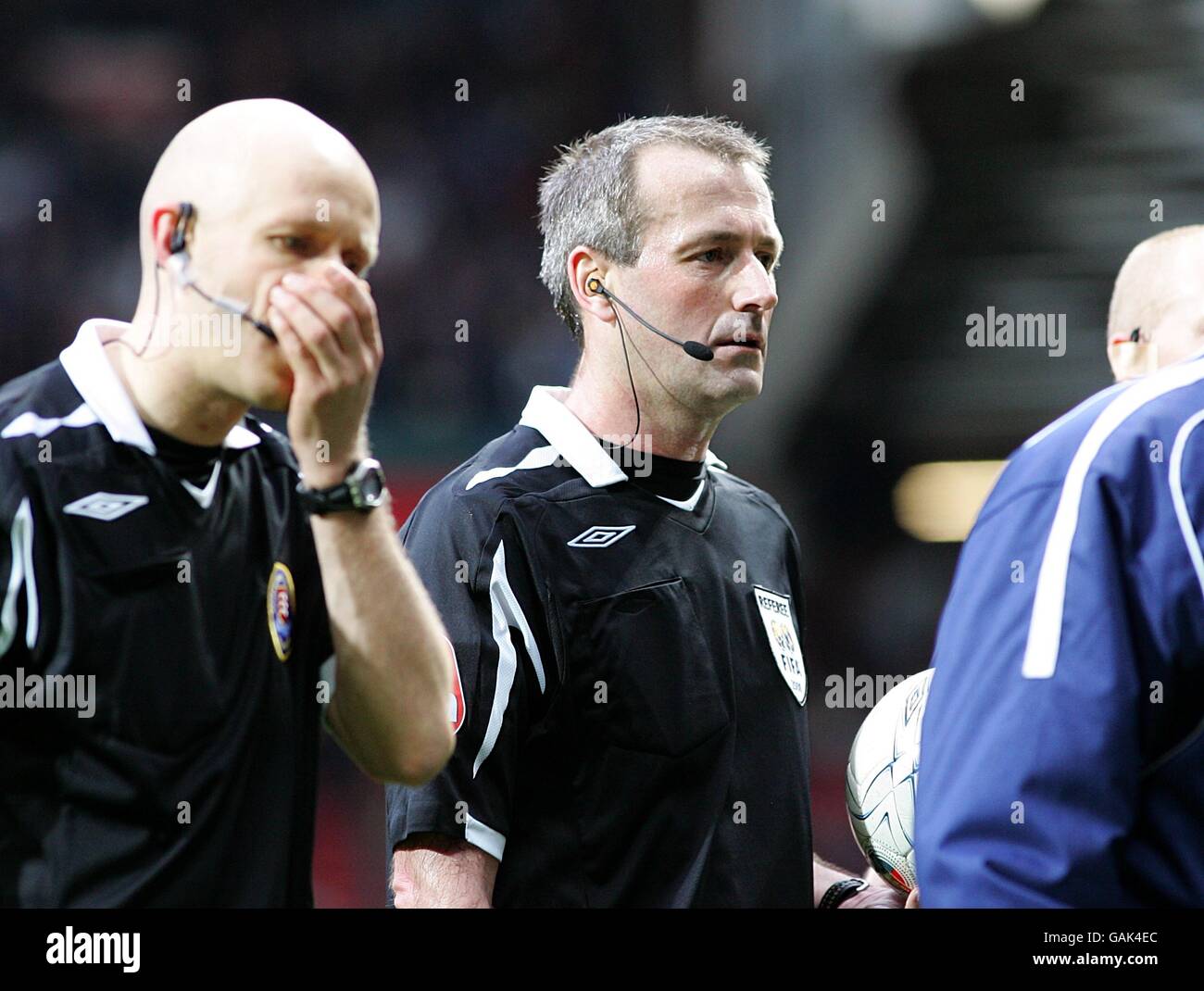 Referee Martin Atkinson walks off the pitch after the final whistle ...