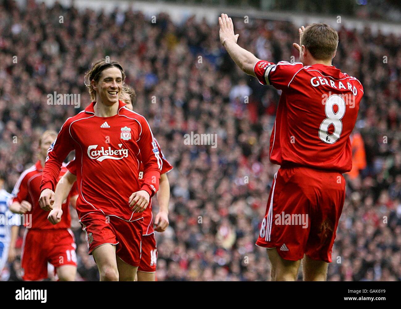 Liverpool's Fernando Torres (left) celebrates scoring the third goal of ...