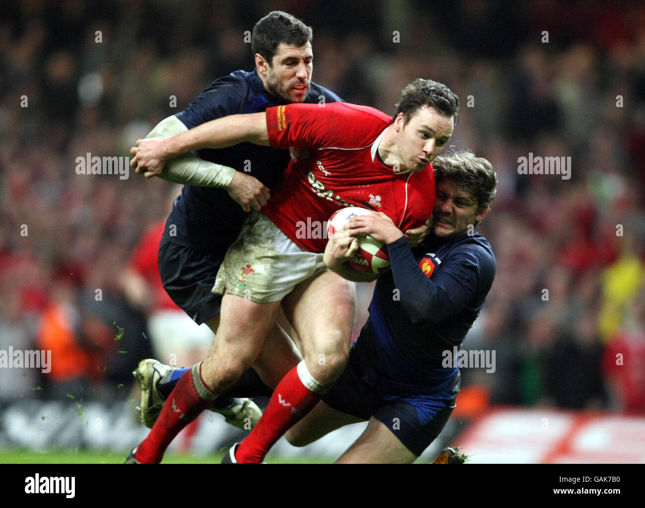 Wales's Mark Jones breaks clear of France's Julien Malzieu and Cedric ...