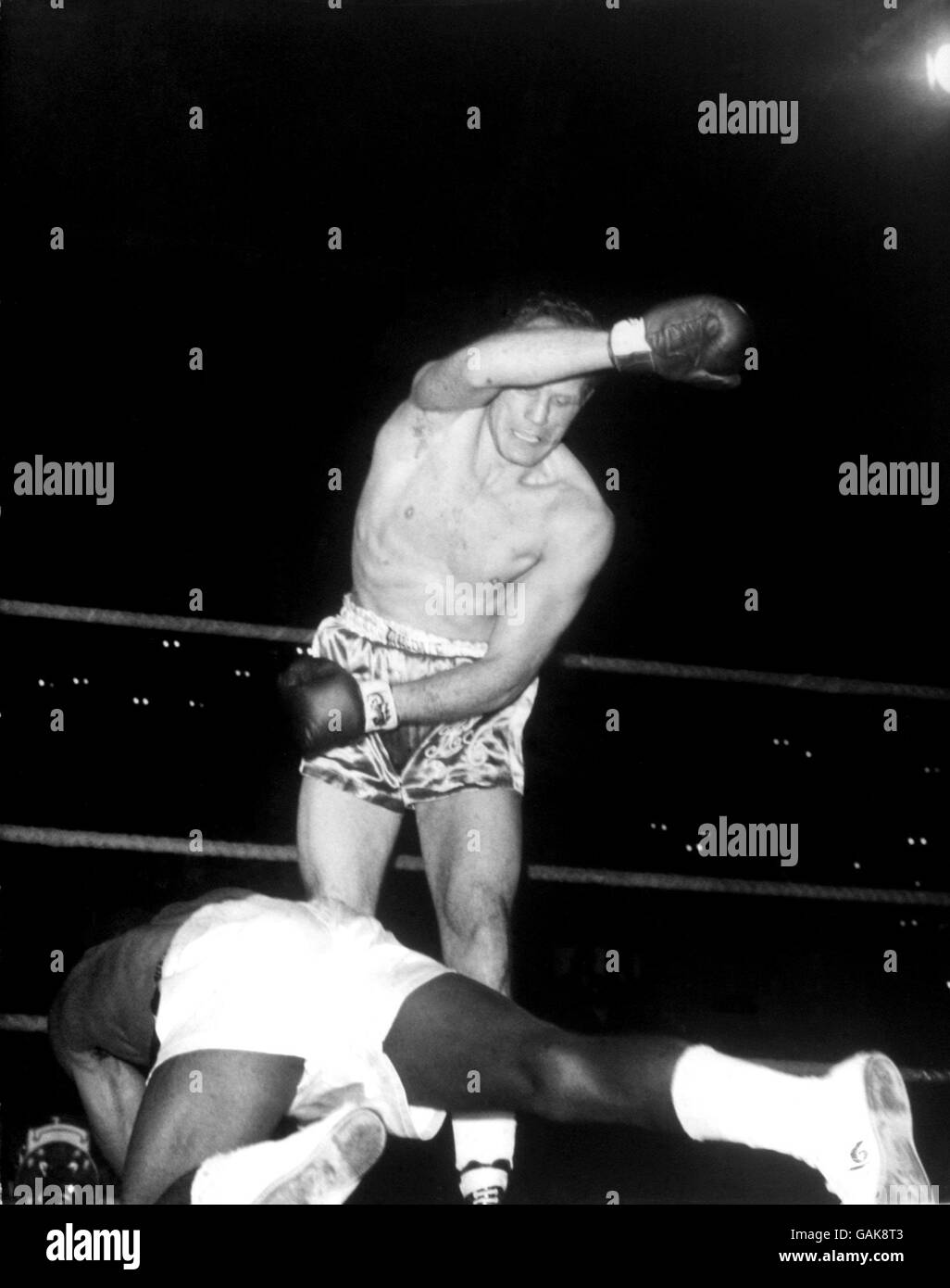 British Heavyweight Champion Henry Cooper (r) follows through with the ...