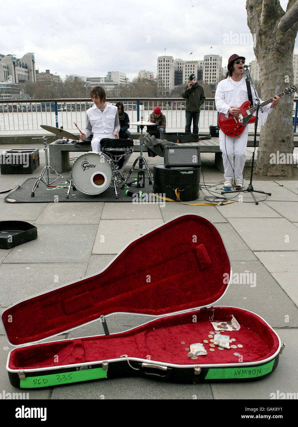 Danny Goffey (left) and Gaz Coombes of Supergrass busk outside the ...