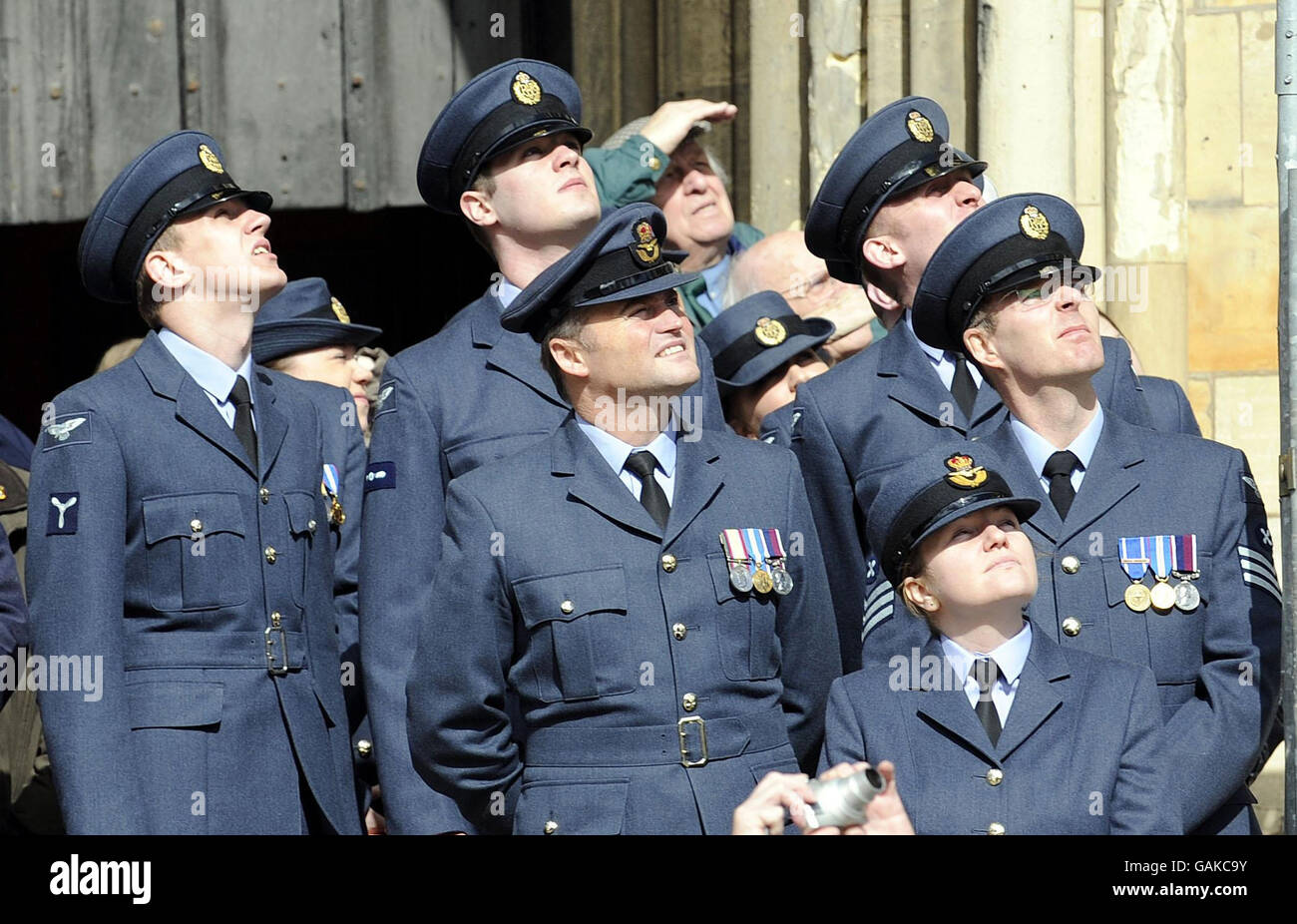 Members of the RAF watch a flypast by Tucano aircraft above York city ...