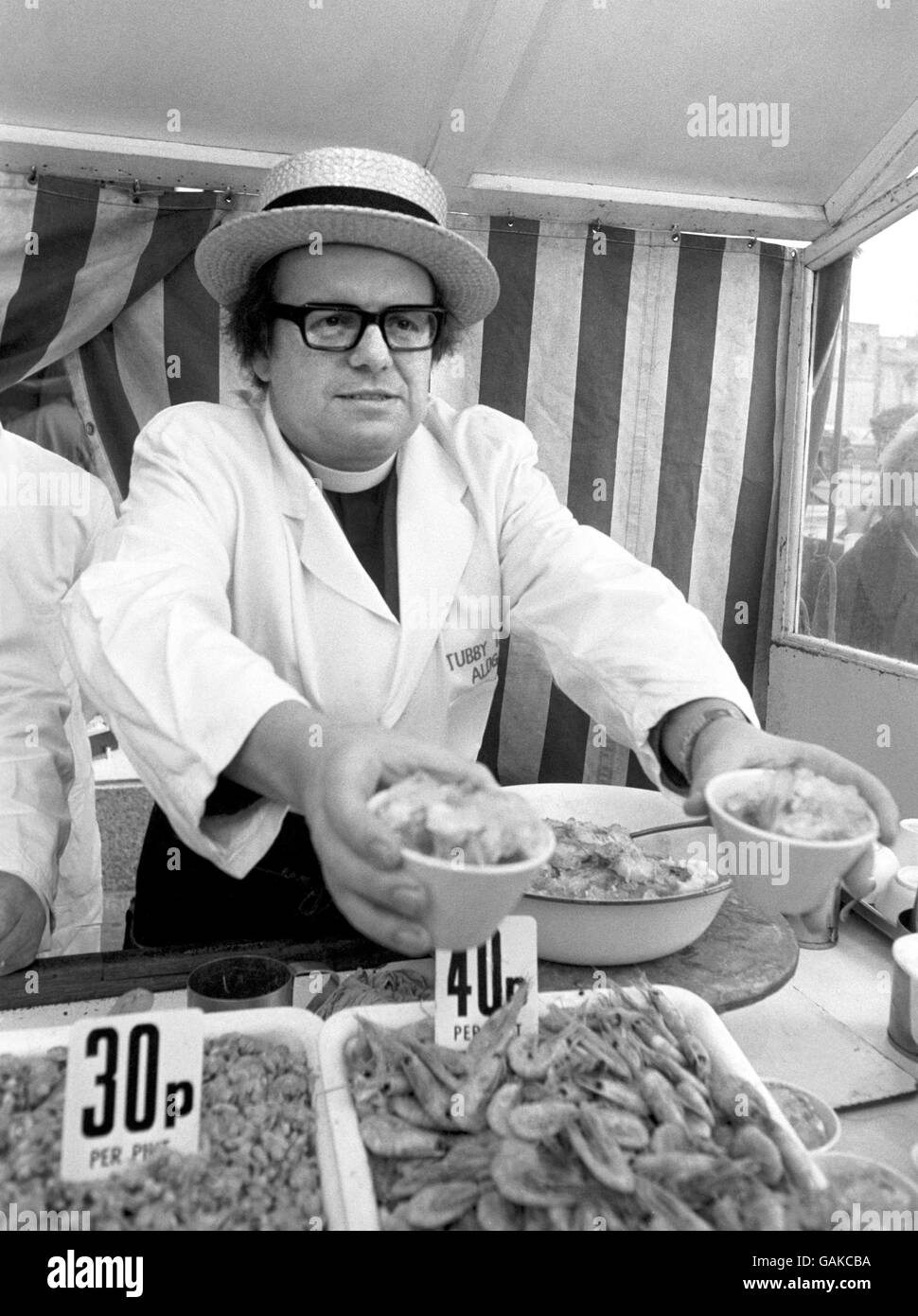 The Reverend John Pellow, a Congregational minister, handing out free ...