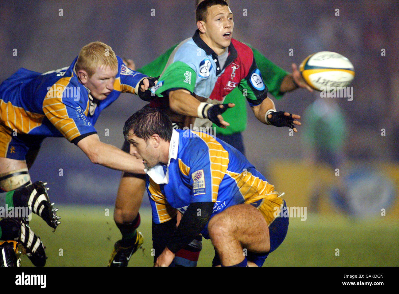 NEC Harlequins' Nick Duncombe gets the ball away just before getting ...