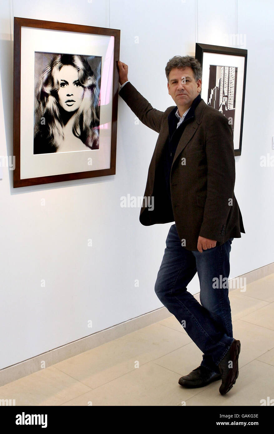 Collector Gert Elfering poses beside a photograph of Brigitte Bardot by ...