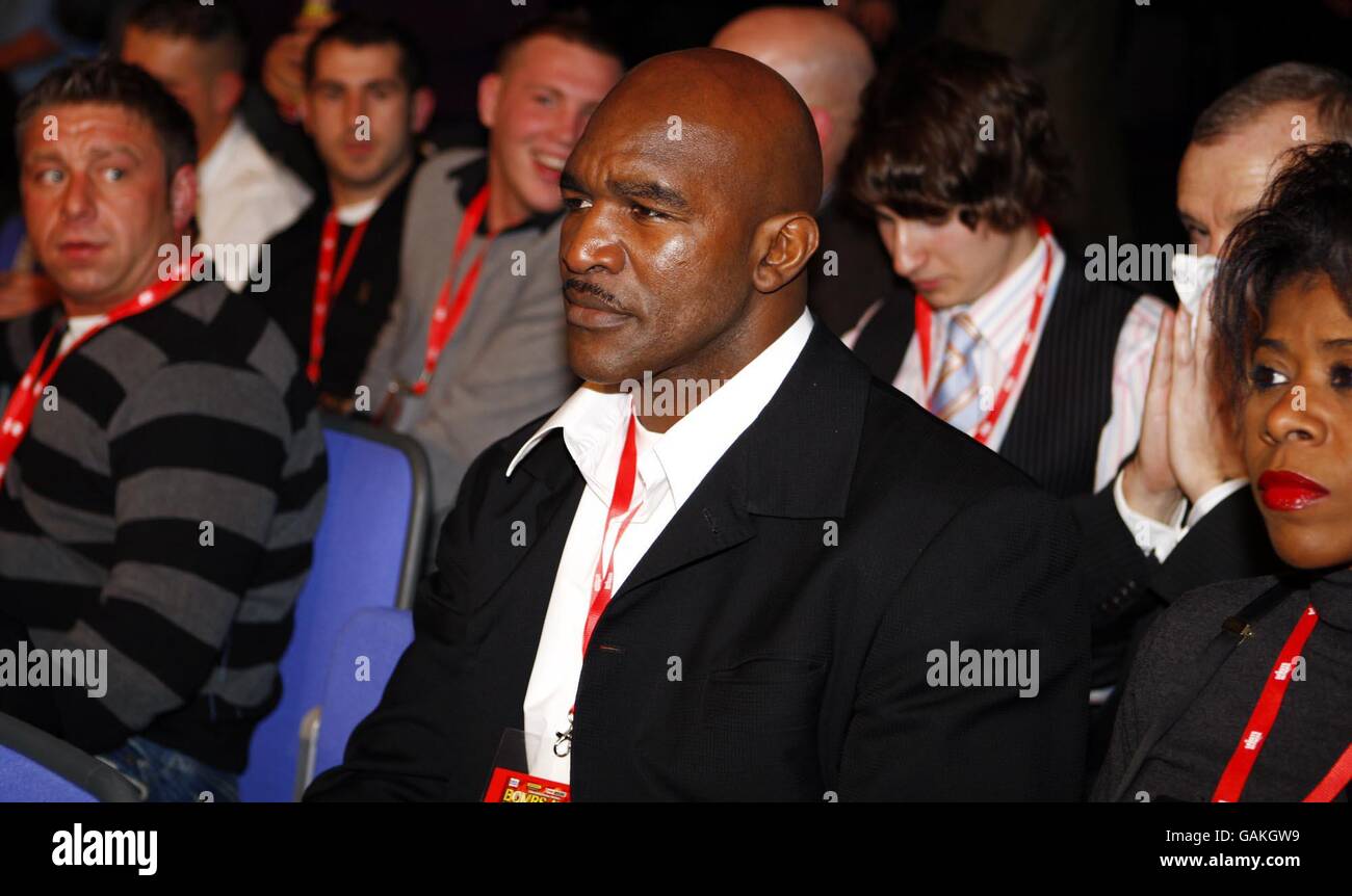 Former World Champion Evander Holyfield watches during the WBC/WBA/WBO ...