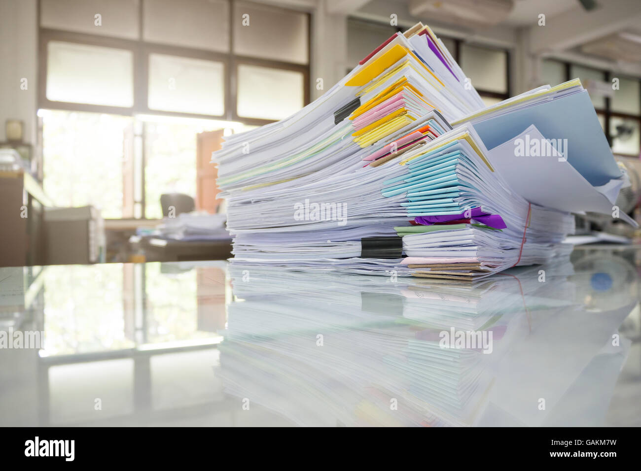 Pile of unfinished documents on office desk, Stack of businesspaper ...