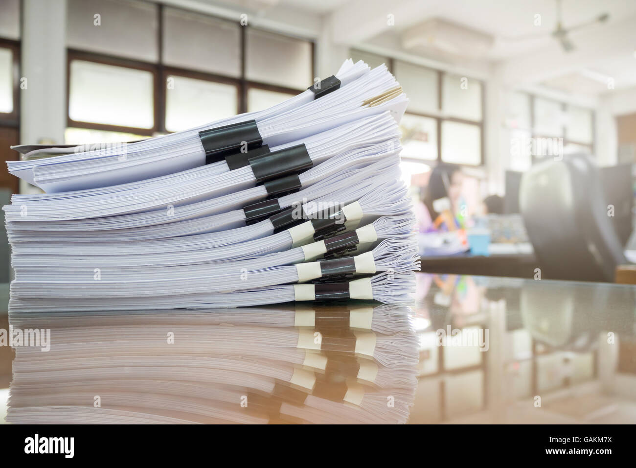 Pile of unfinished documents on office desk, Stack of businesspaper ...