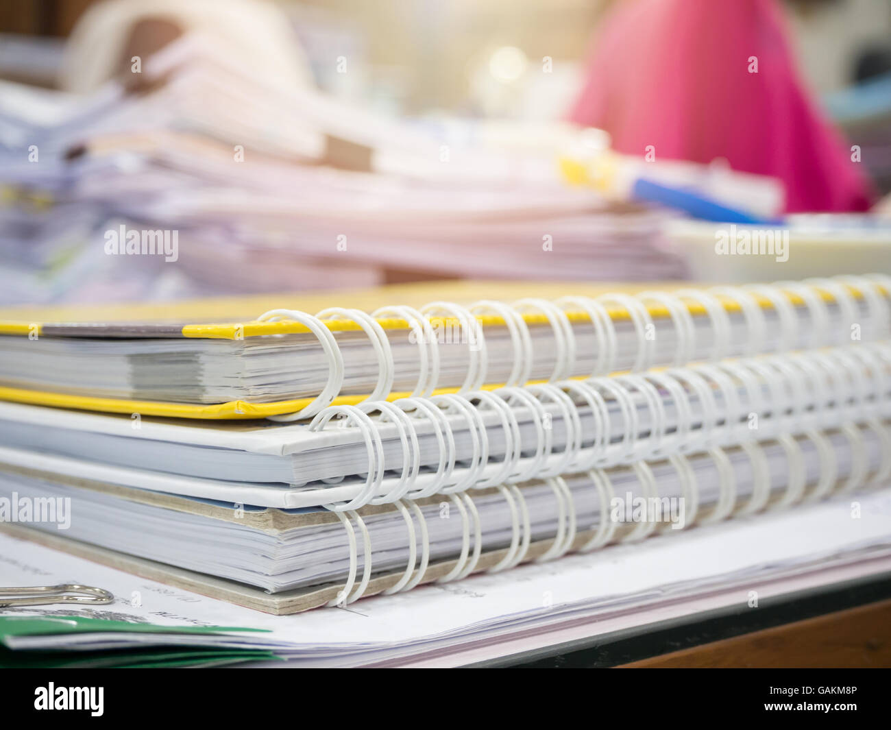 Messy office desk, Close up stack of notebook Stock Photo - Alamy