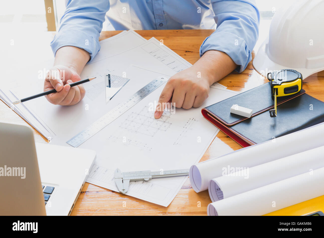 Architects working with blueprints in the office Stock Photo - Alamy