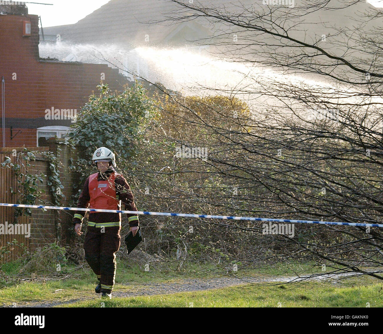 A fireman walks close to a house in Broadwater Gardens, Farnborough ...