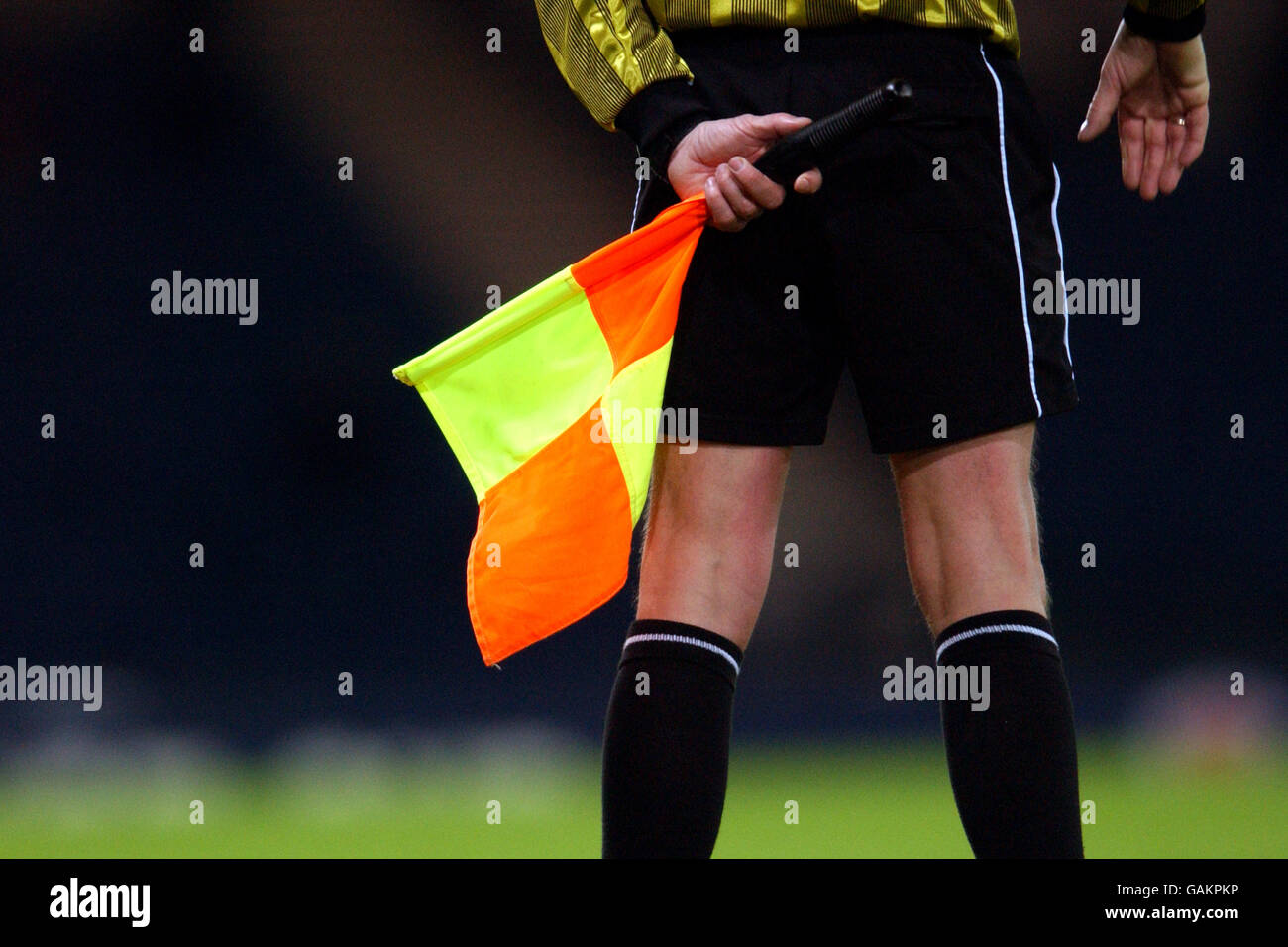The assistant referee holding his flag behind his back hi-res stock ...